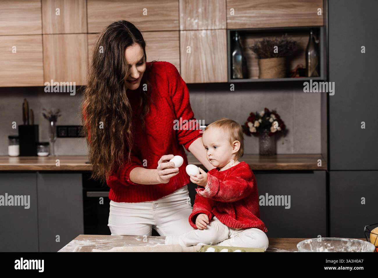 Mother and little helper daughter are preparing cookies and having fun ...
