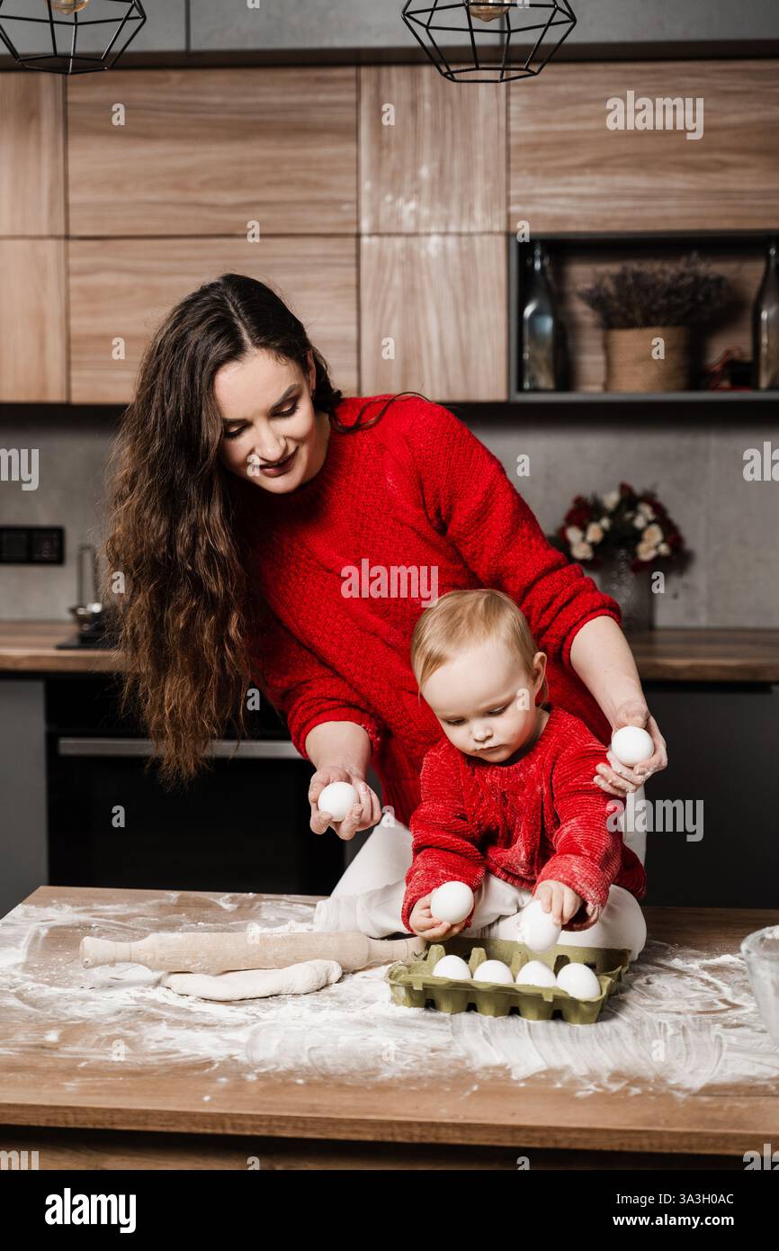 Mother and little helper daughter are preparing cookies and having fun ...
