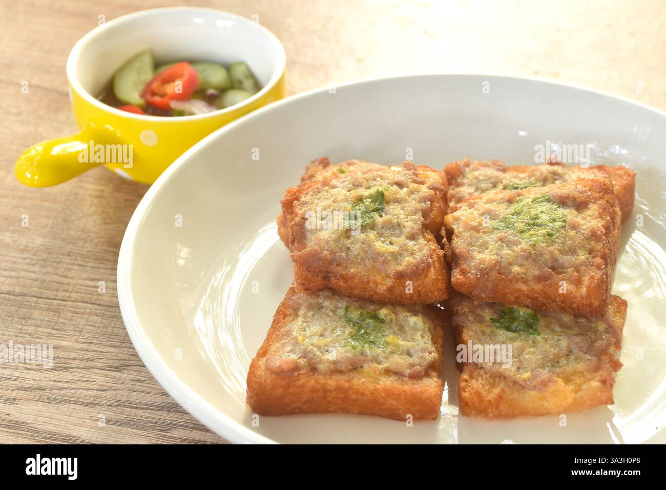 Thai crispy fried pork toast on plate eat couple with pickled vegetable ...