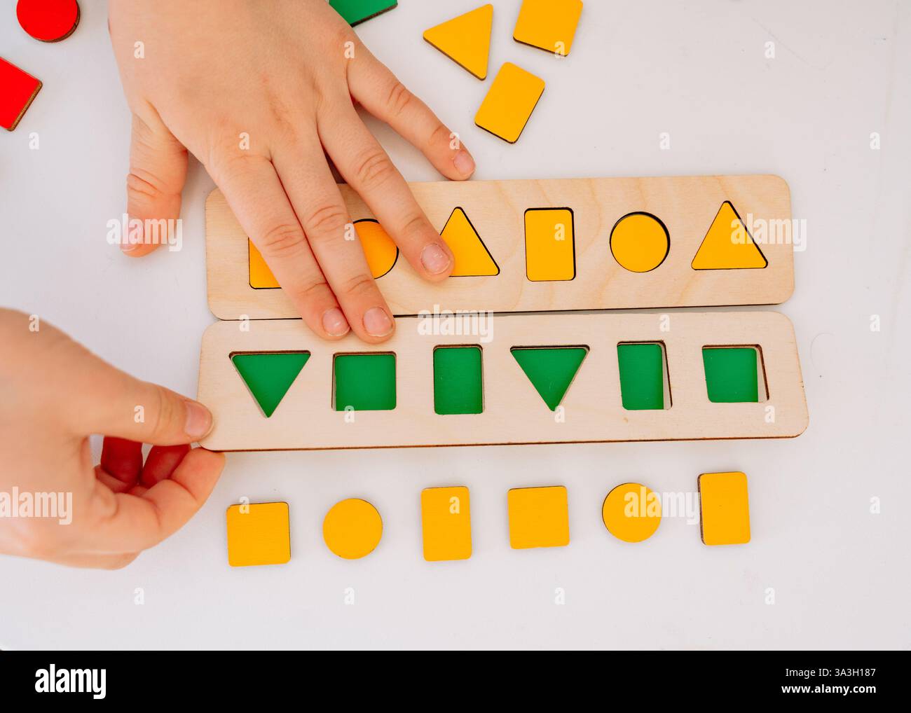 Child arranges colorful geometric shapes hi-res stock photography and ...