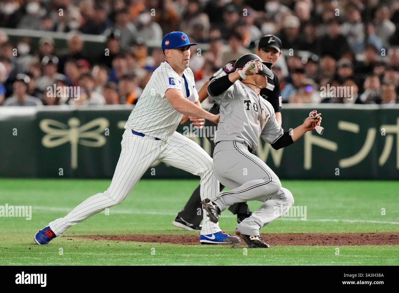 Yomiuri Giants' Raito Nakayama, right, is tagged out by Chicago Cubs ...