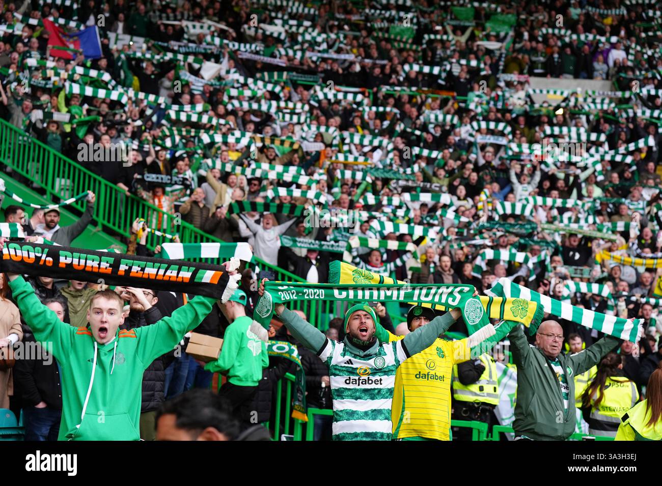 Celtic fans in the stands hold their scarves in the air during the ...