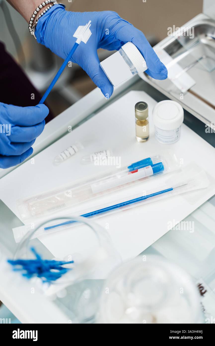 Gynecologist is holding flask for cytology Pap smear test in hands ...