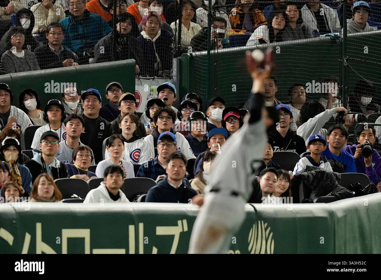Fans look on as Yomiuri Giants third baseman Raito Nakayama, front ...
