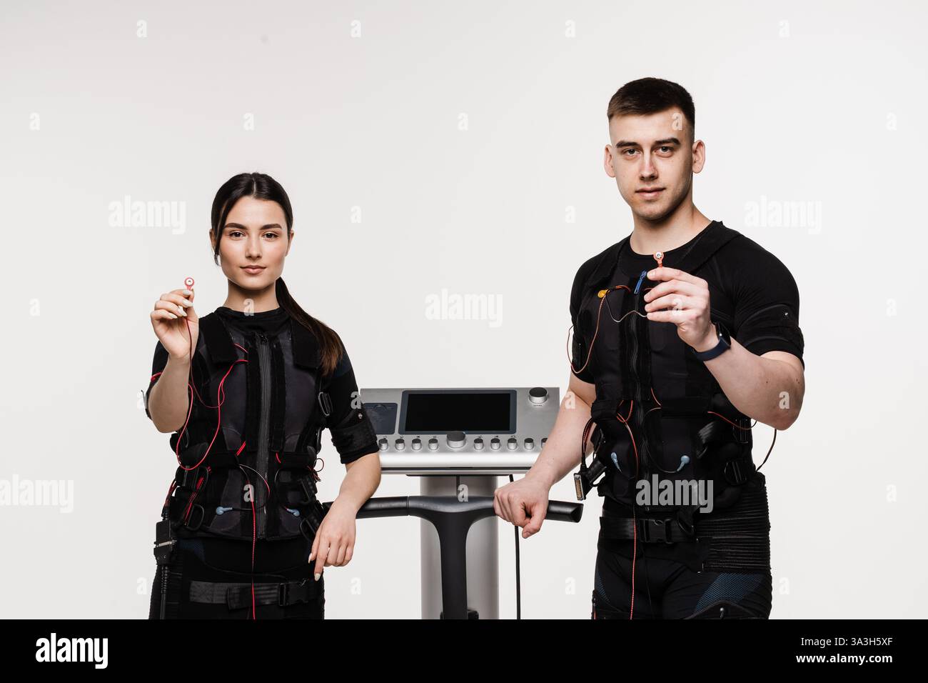 Man and woman in EMS suit with contactor in hands that uses electrical ...