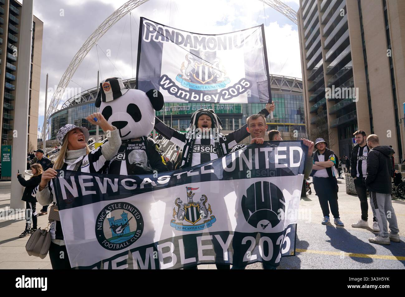 Newcastle United fans pose with a person dressed as a panda outside ...