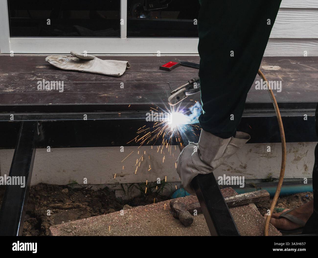 Worker welder performs Arc welding process of metal structures Stock ...