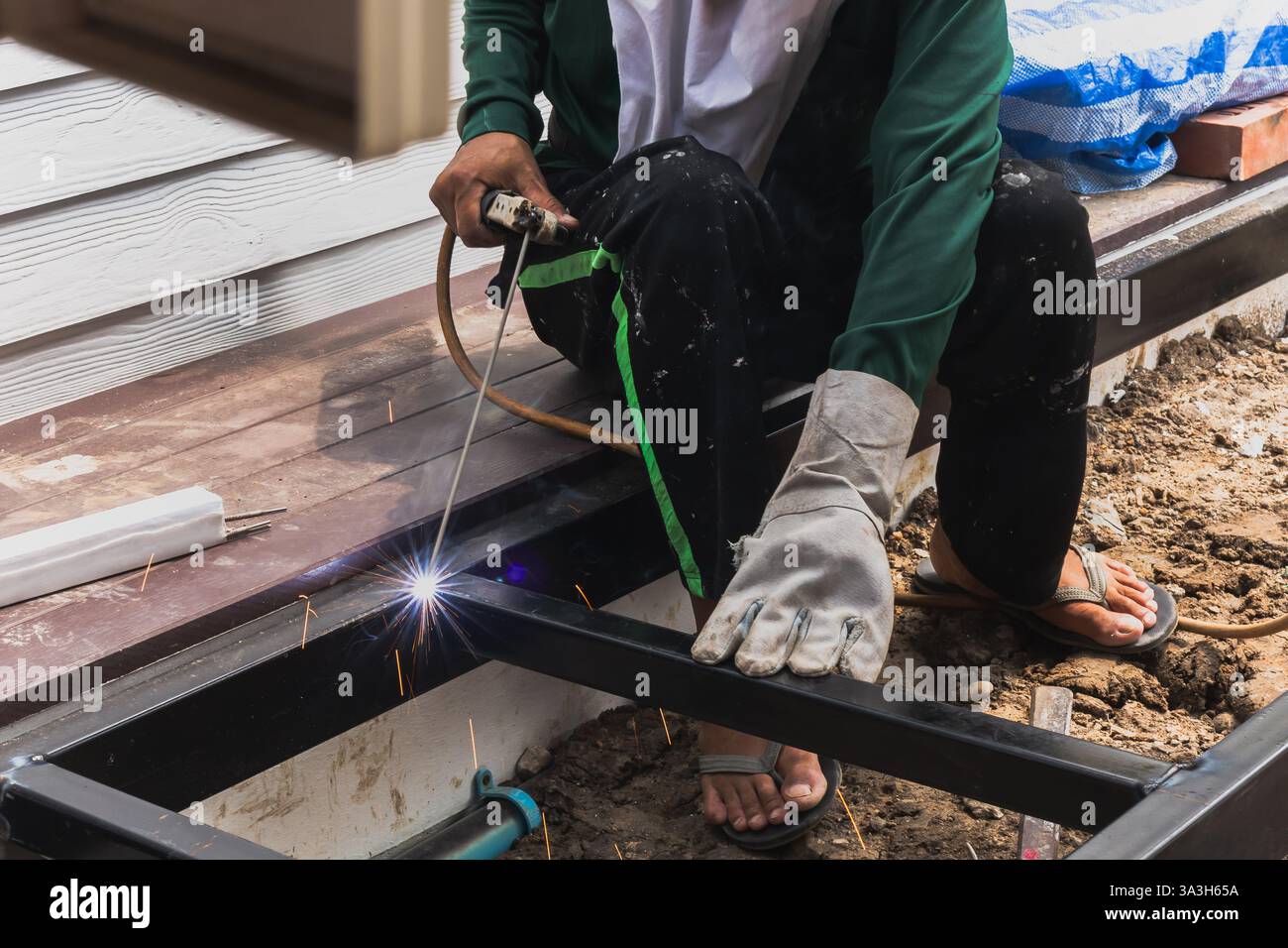 Worker welder performs Arc welding process of metal structures Stock ...
