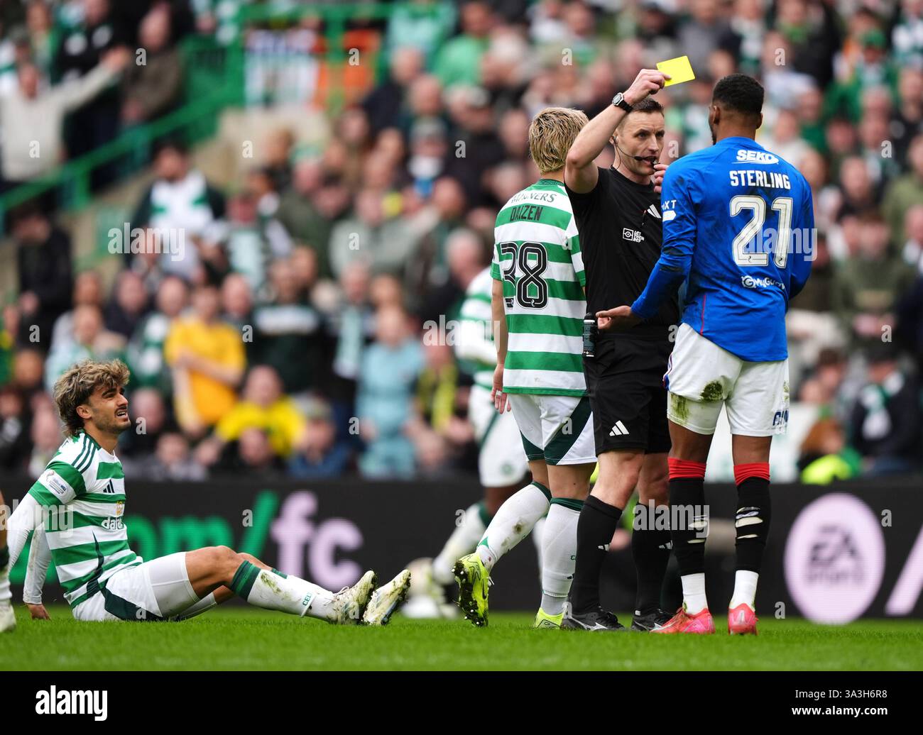 Referee Steven McLean shows a yellow card to Rangers' Dujon Sterling ...