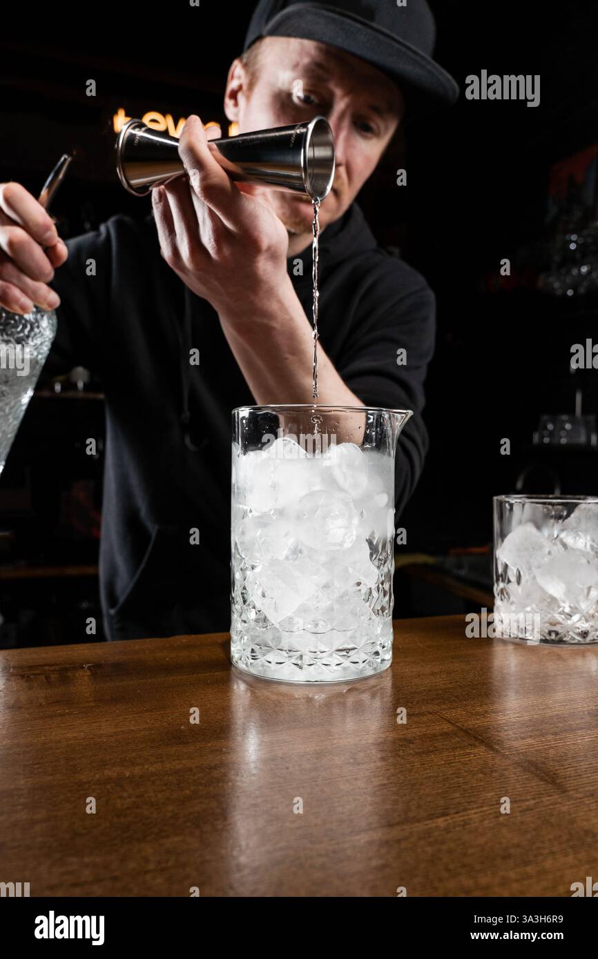 Bartender prepares traditional Negroni cocktail at the bar. Bartender ...