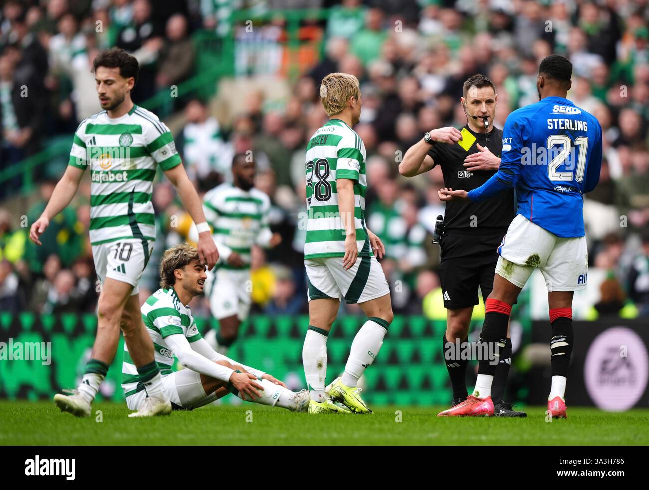 Referee Steven McLean shows a yellow card to Rangers' Dujon Sterling ...