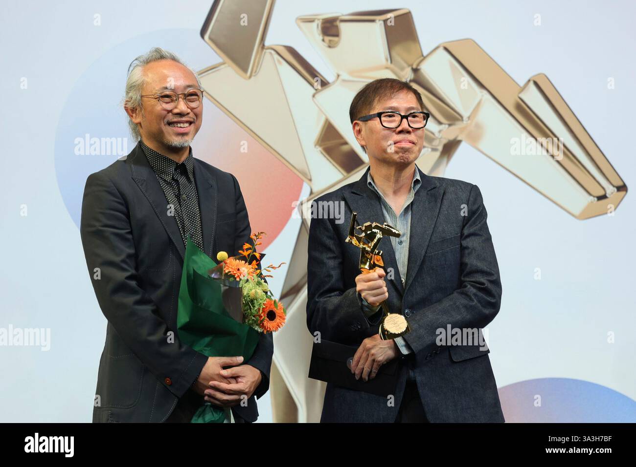 Kenneth Mak and Chau Sai Hung Ambrose pose with their trophies after ...