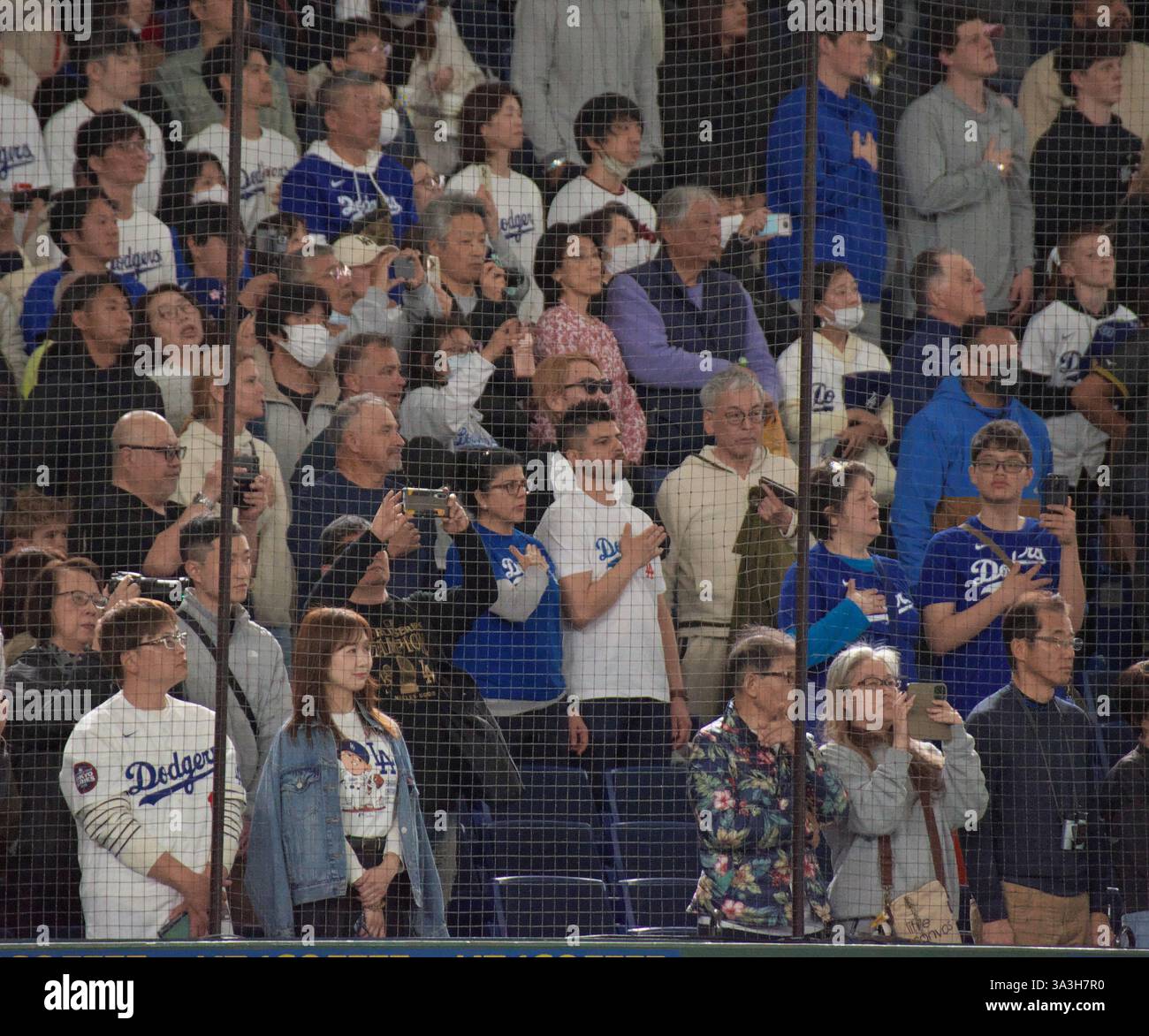 Tokyo, Japan. 16th Mar, 2025. Spectators stand for the national anthem ...