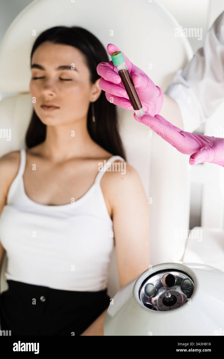 Cosmetologist insert test tube with blood in centrifuge to get plasma ...