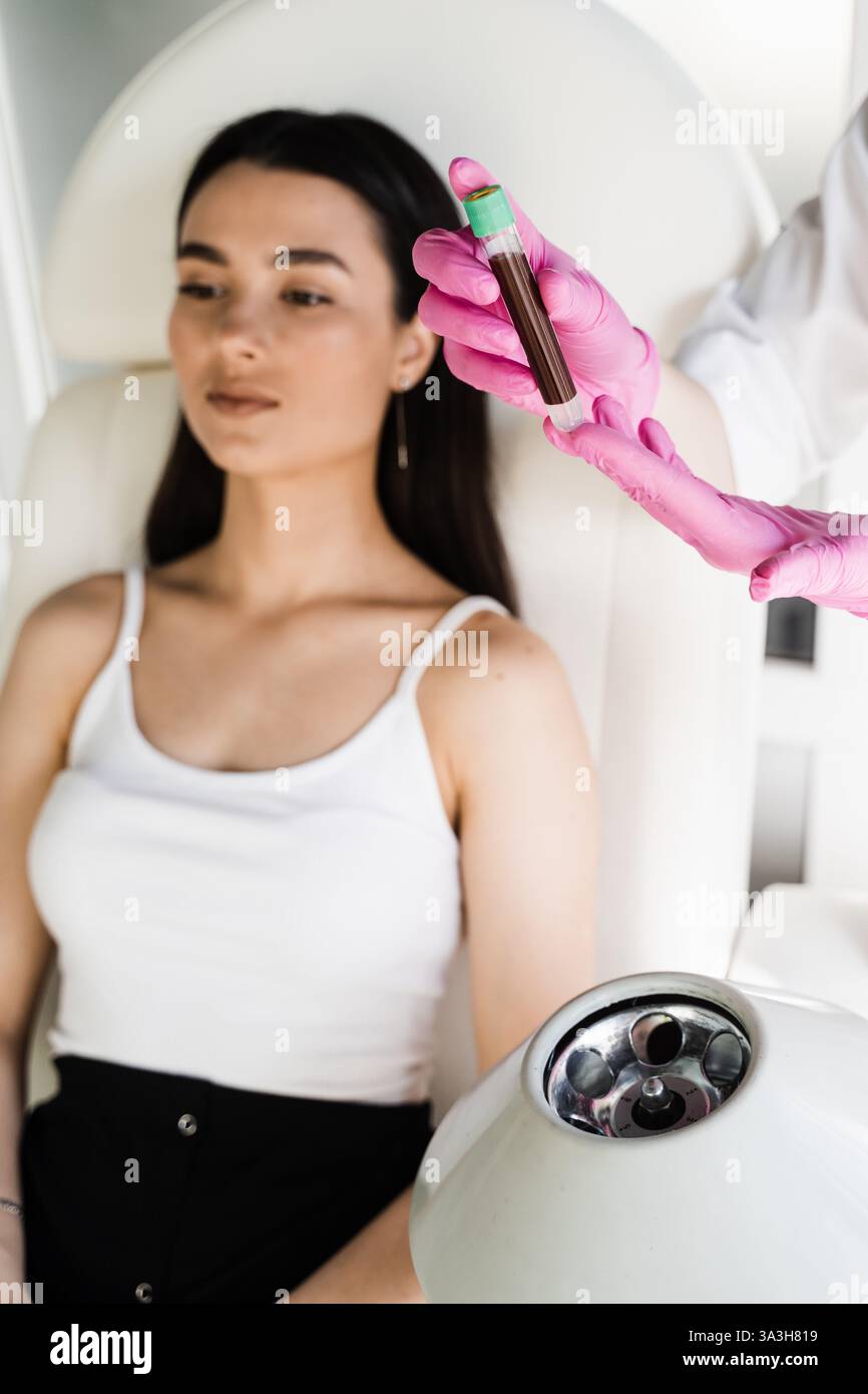 Cosmetologist insert test tube with blood in centrifuge to get plasma ...