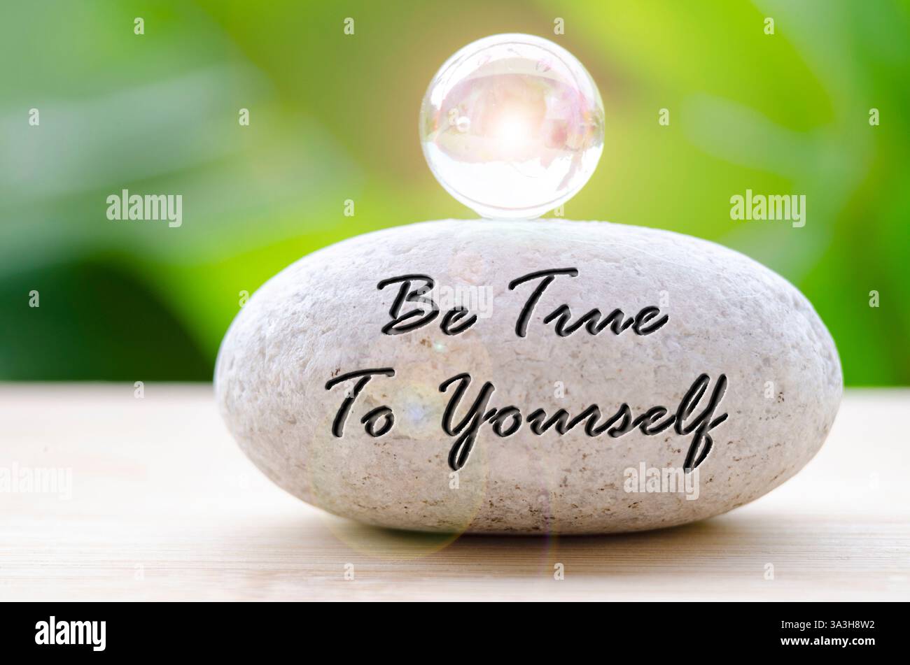 Close up of Zen stone with Be True To Yourself text on the stone. Self ...