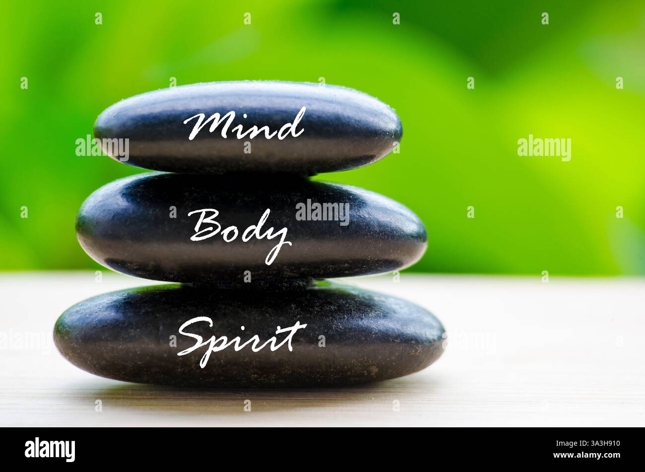 Close up of black Zen stones with Mind Body and Spirit text on the ...