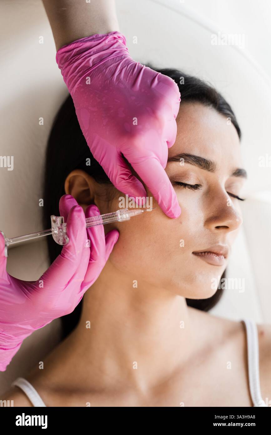 Filler injection of hyaluronic acid in cheekbones. Contour plastic for ...