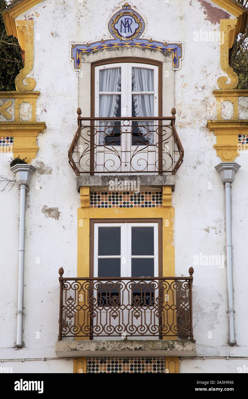 Balconies of a beautifully detailed building in Obidos reflect the town ...