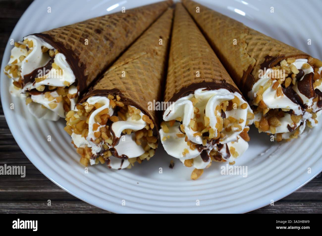 Biscuit ice cream cone, melting cold ice cream twirl in a wafer ...