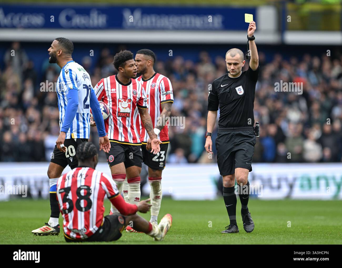 Referee Andrew Kitchen shows Sheffield United's Femi Seriki a yellow ...