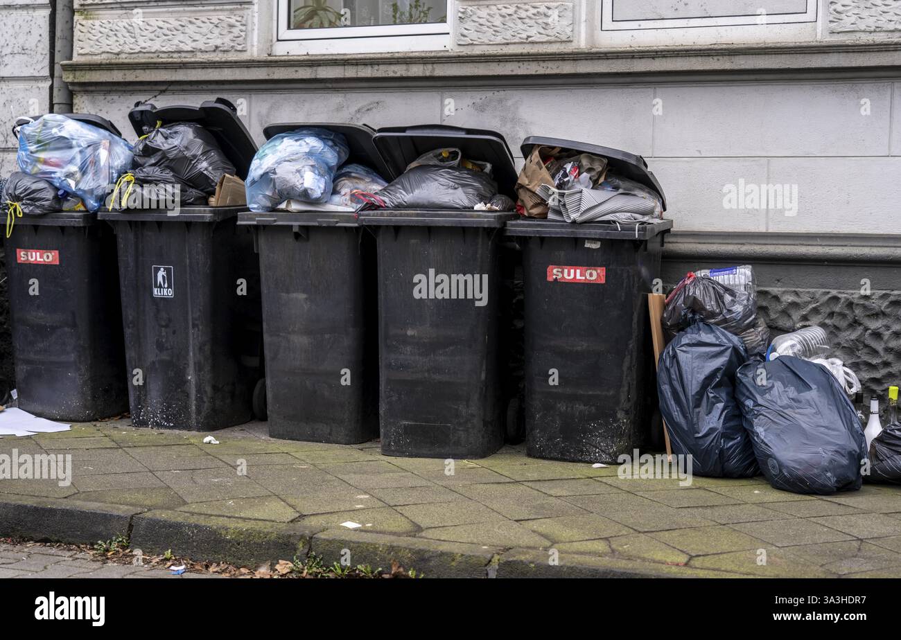 Overflowing rubbish bins in front of a residential building in ...
