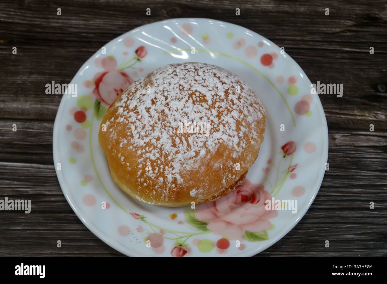 Icing powdered sugar round donut, a glazed, yeast raised, American ...
