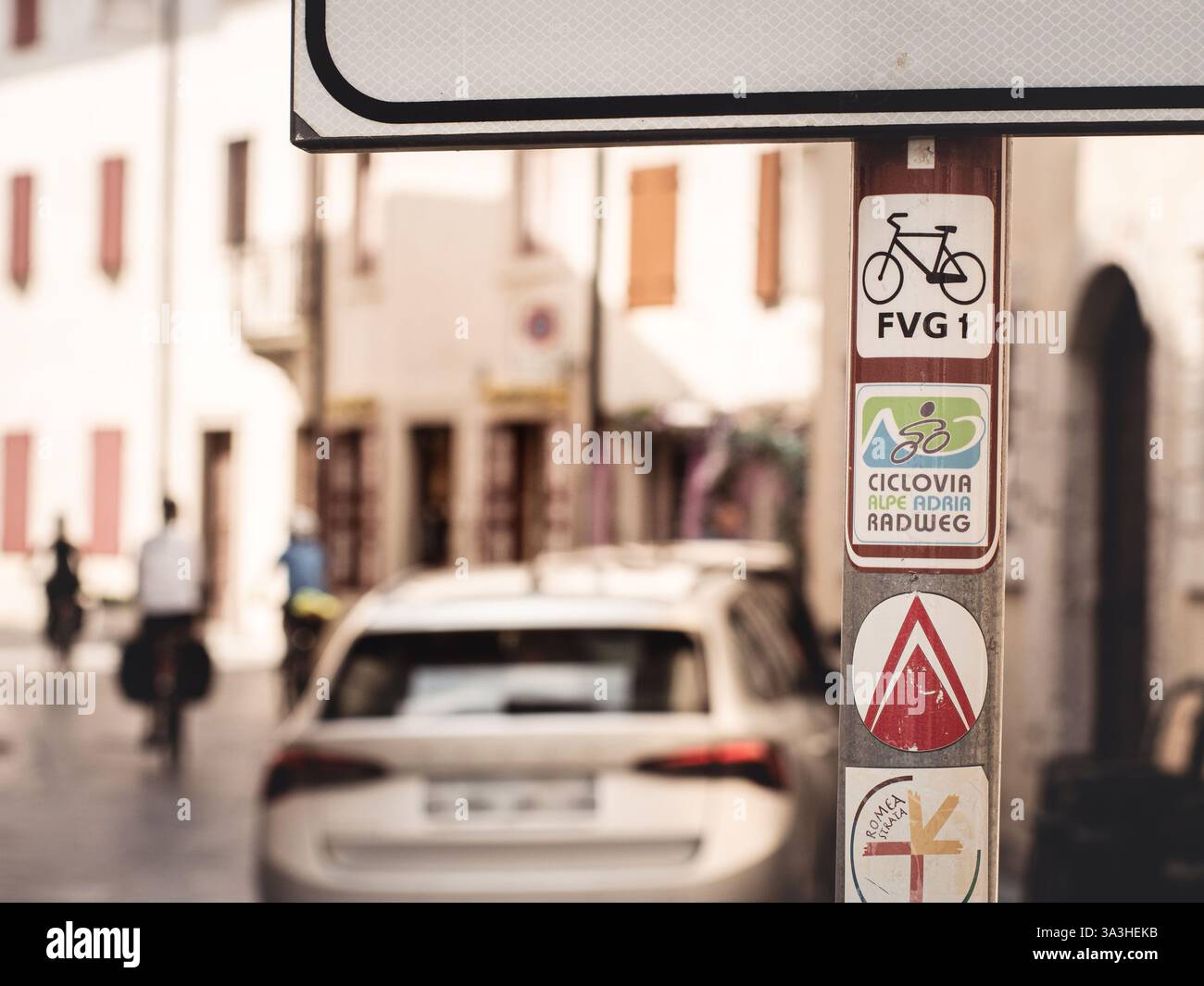 20th of May, 2024 - Venzone, Italy: A bicycle route signpost marking ...