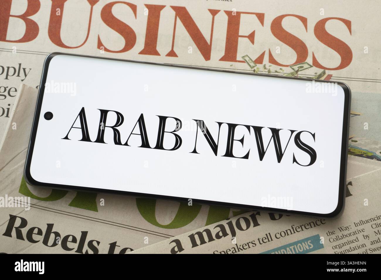 The logo of the ARAB NEWS is displayed on a smartphone screen Stock ...