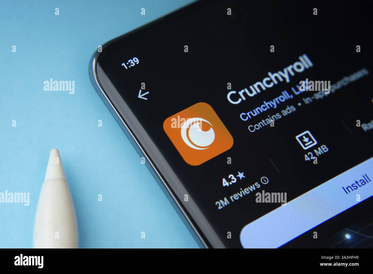 The Crunchyroll app from Google Playstore is displayed on a smartphone ...