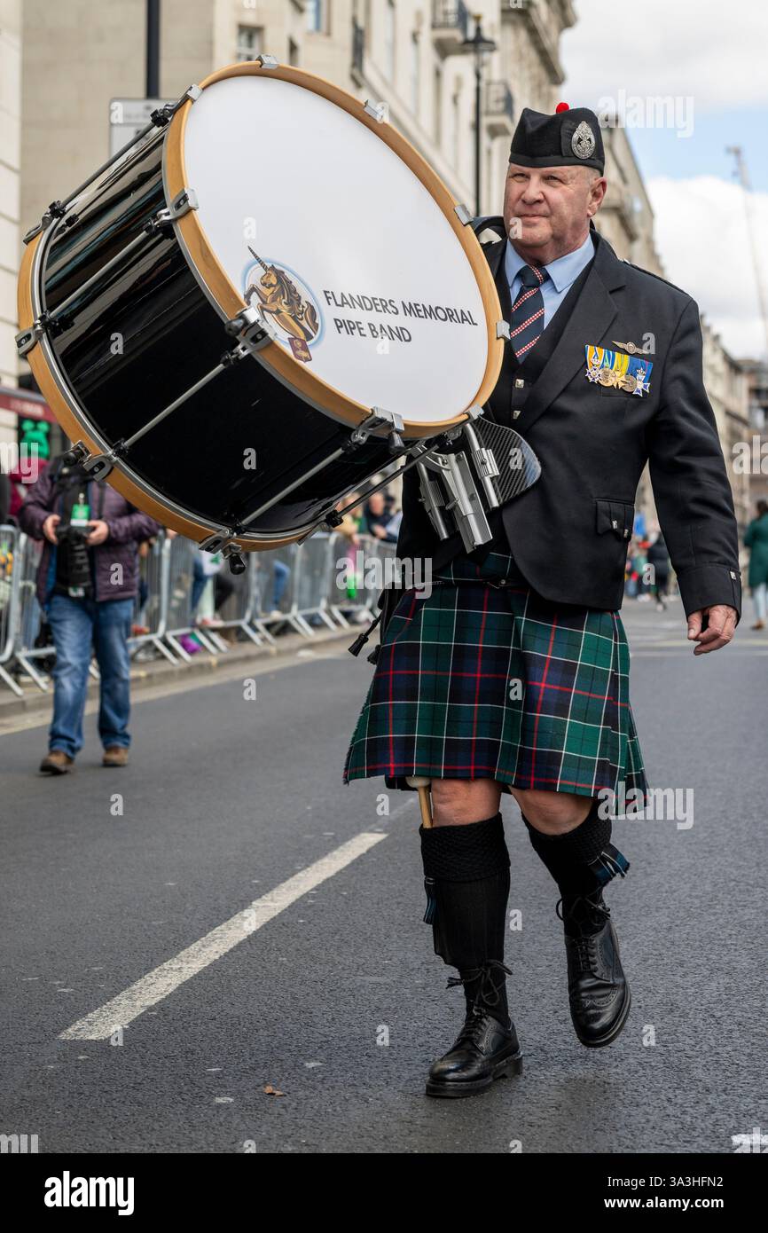 London, UK. 16 March 2025. A member of the Flanders Memorial Pipe band ...