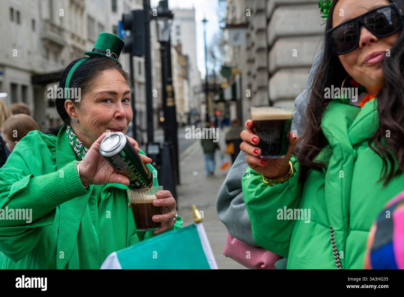London, UK. 16 March 2025. Women drinking Guinness watches the annual ...