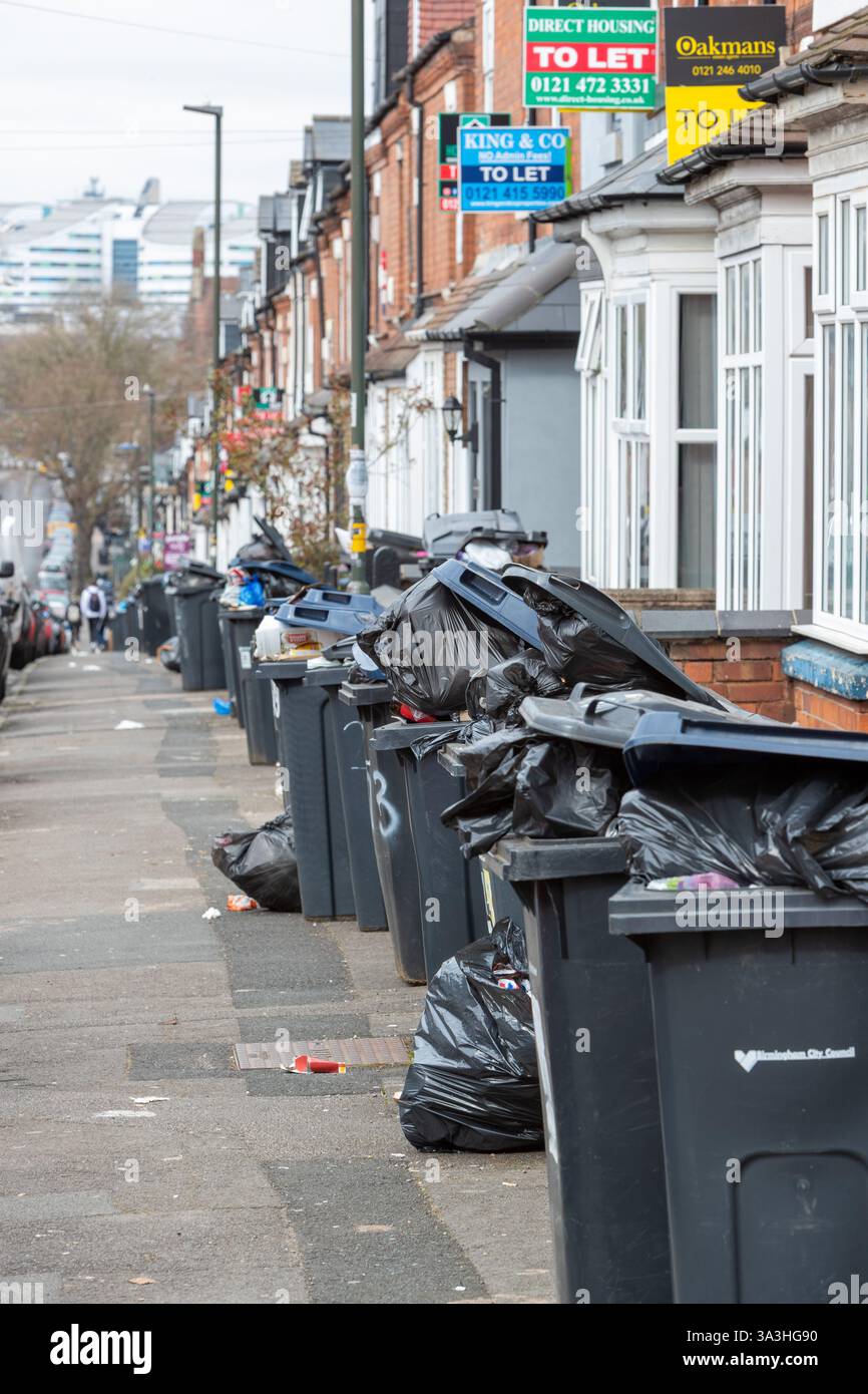 Birmingham, UK. 16th Mar, 2025. Overflowing bins lie uncollected on the streets of Selly Oak in ...