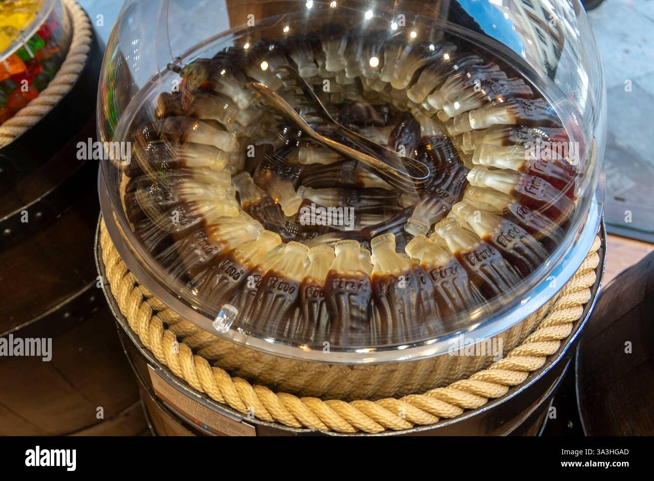 A colorful bucket filled with gummy bears placed under a dome lid Stock ...