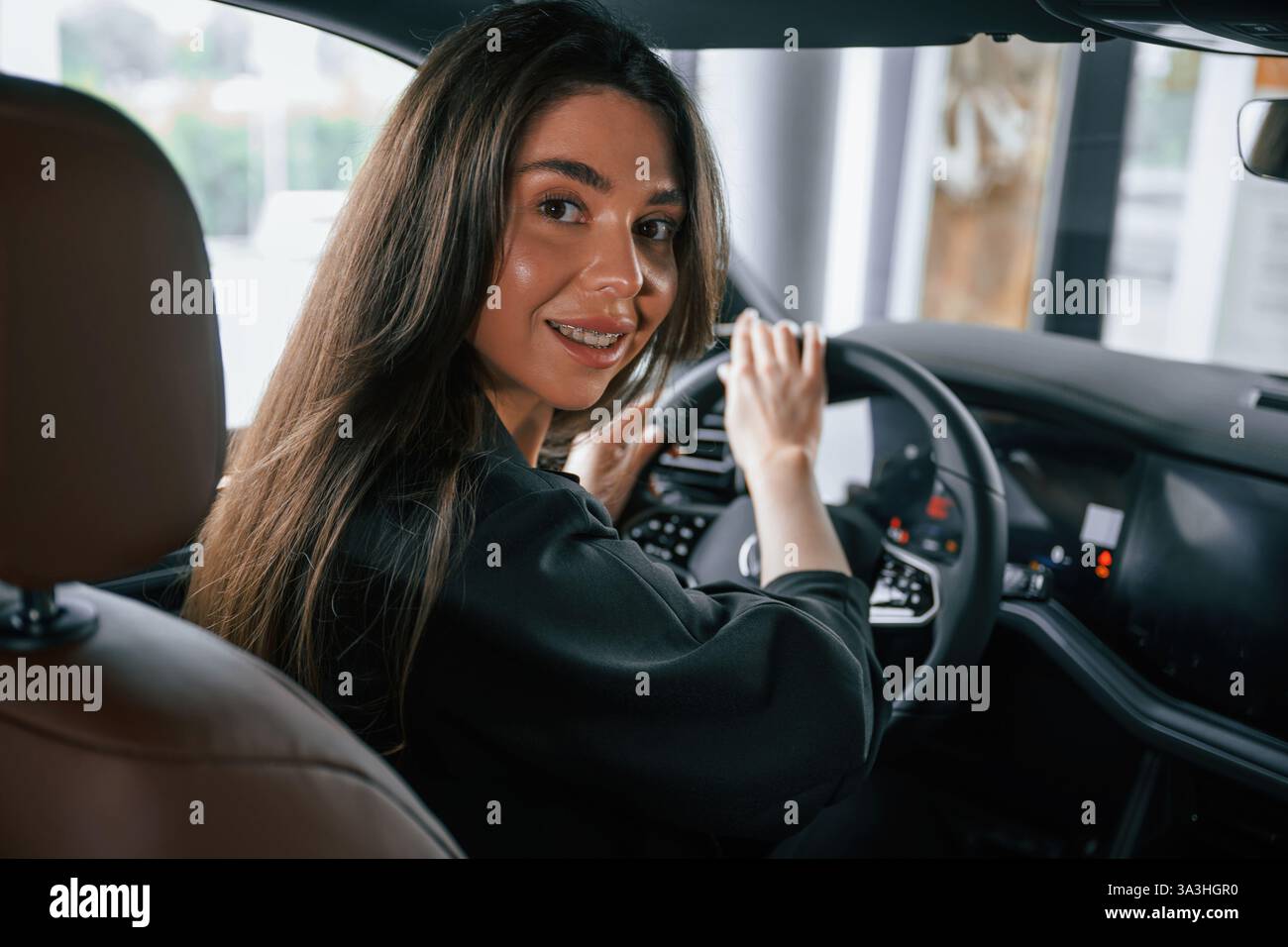 Conception of test drive. Beautiful businesswoman is in the new car ...