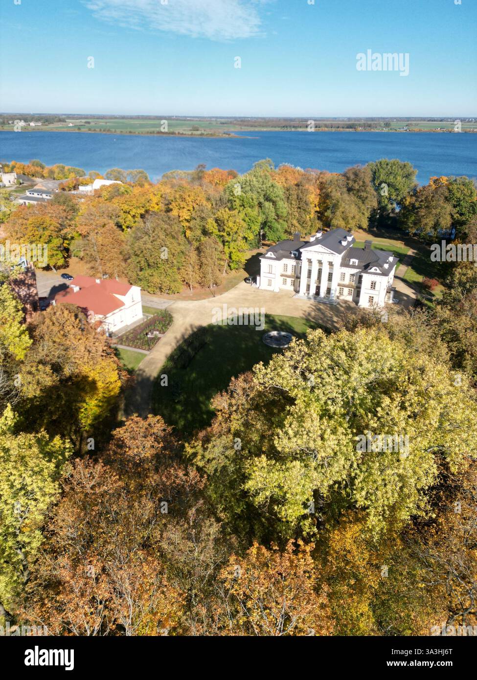 Aerial View of a Manor Surrounded by trees in autumn by the lake Stock ...