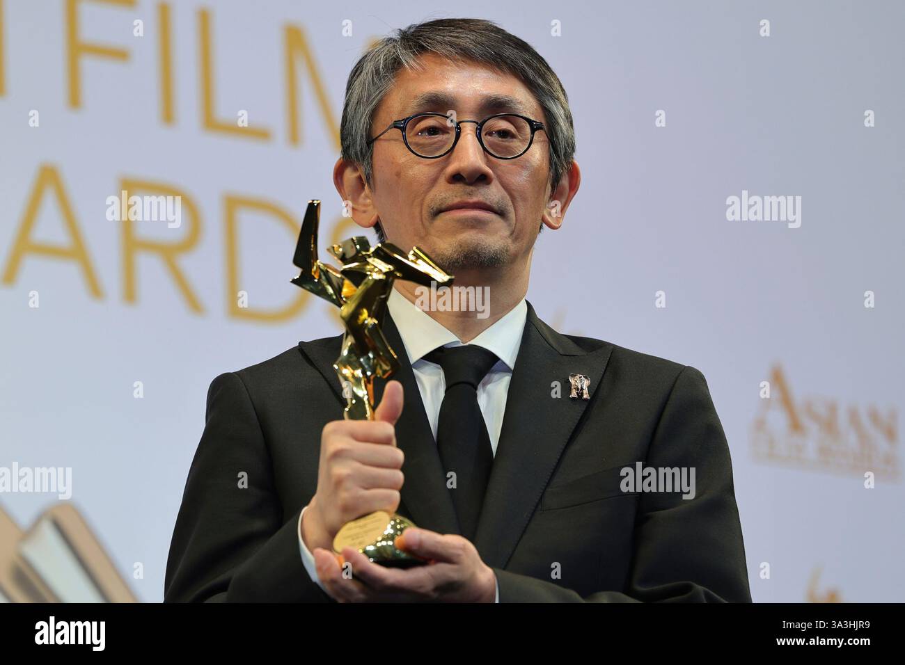 Daihachi Yoshida, winner of Best Director for the movie Teki Cometh, poses with his trophy after ...