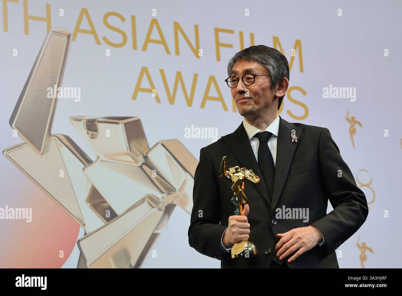 Daihachi Yoshida, winner of Best Director for the movie Teki Cometh, poses with his trophy after ...