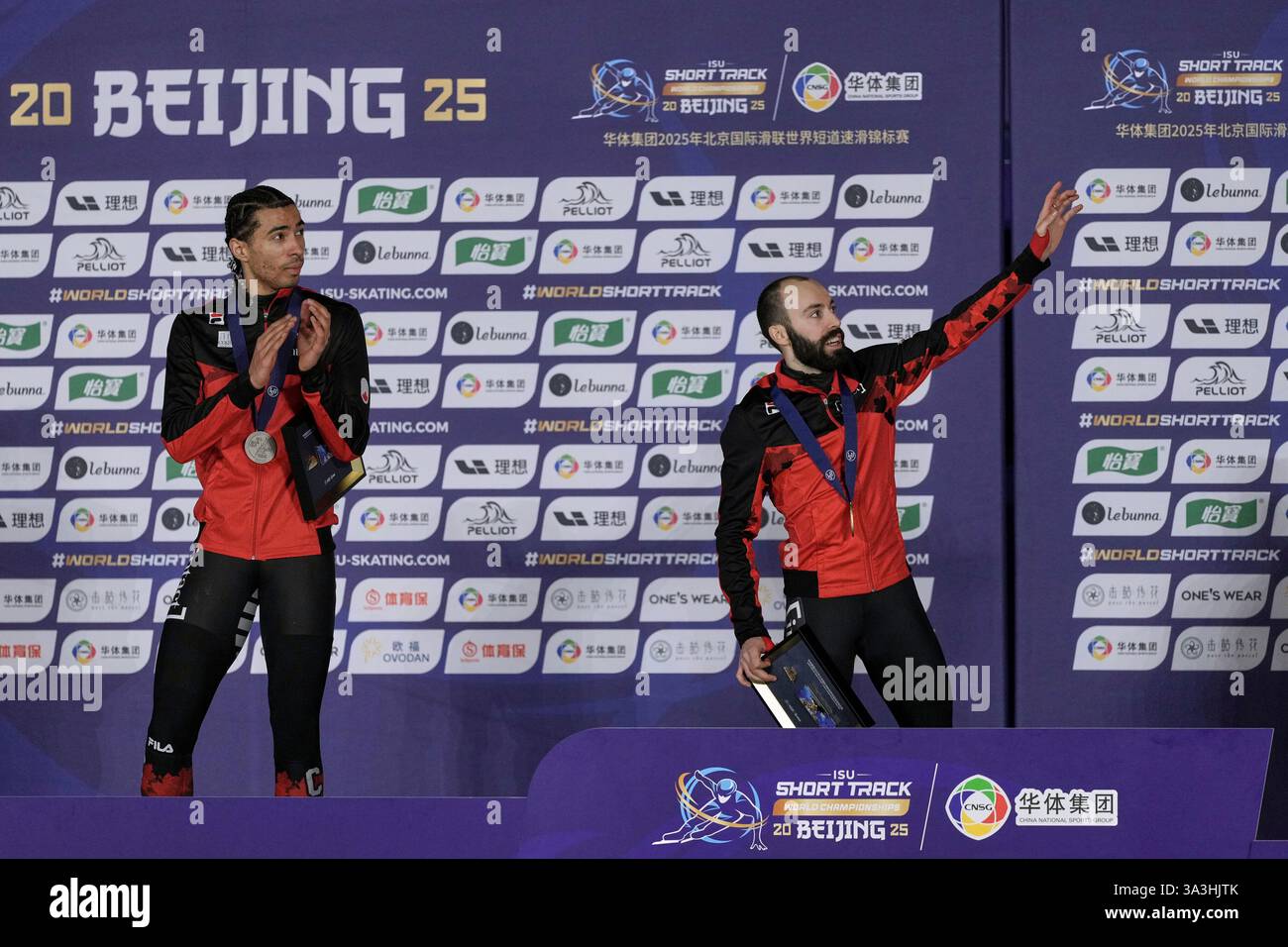 Gold medalist Steven Dubois of Canada, right, waves next to teammate ...