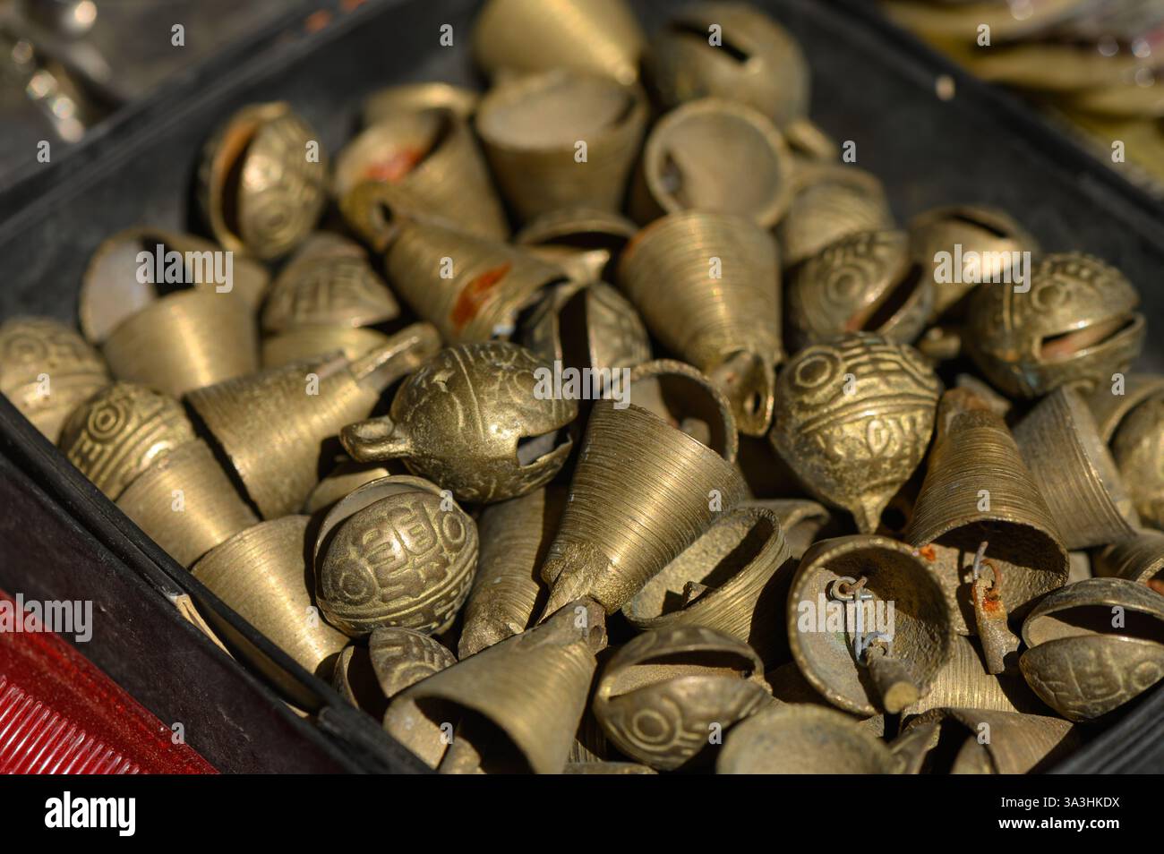 A collection of beautiful, handcrafted metal bells glistens under the ...