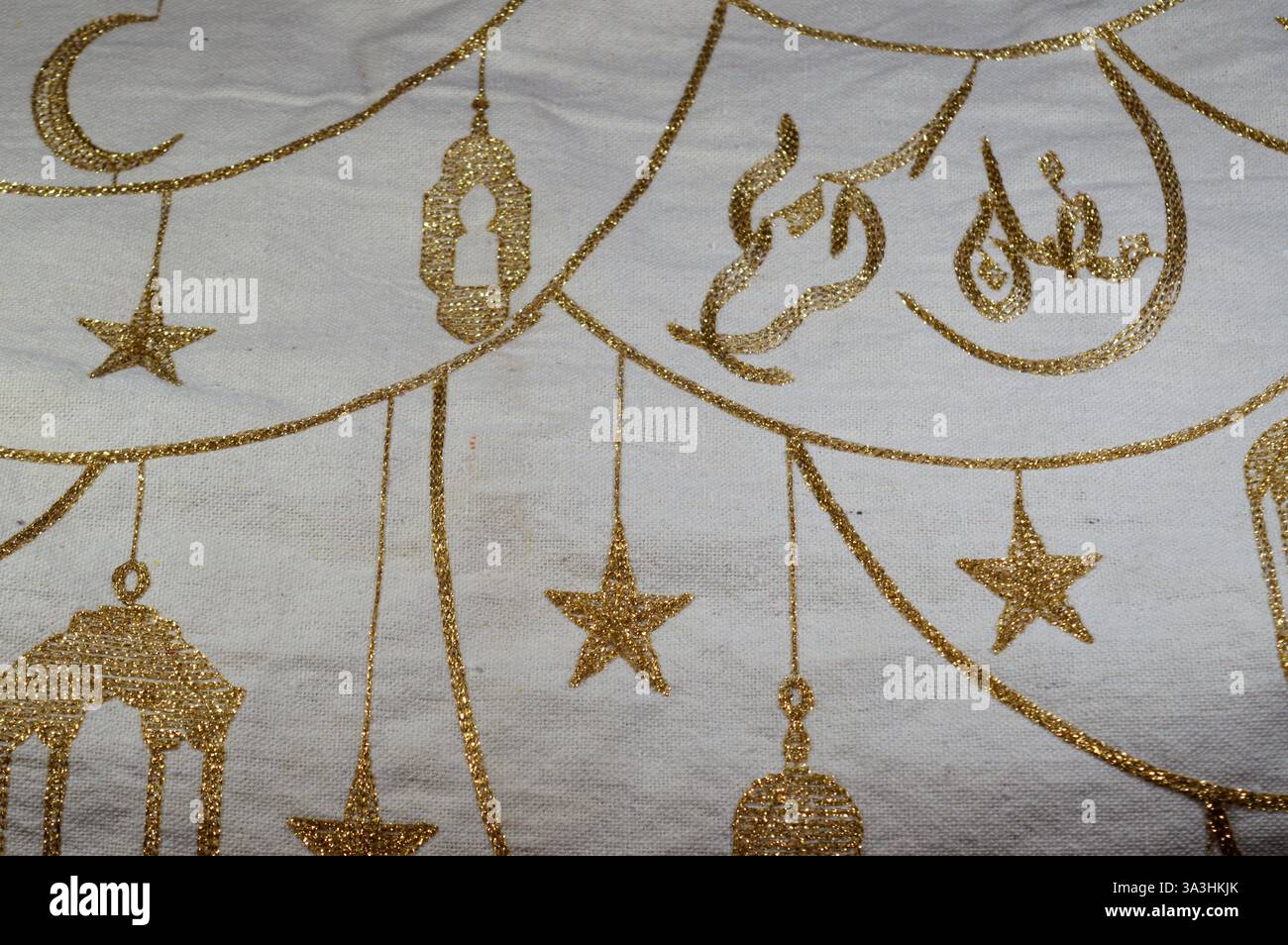 Translation of Arabic text (Happy generous Ramadan) on a fabric with ...