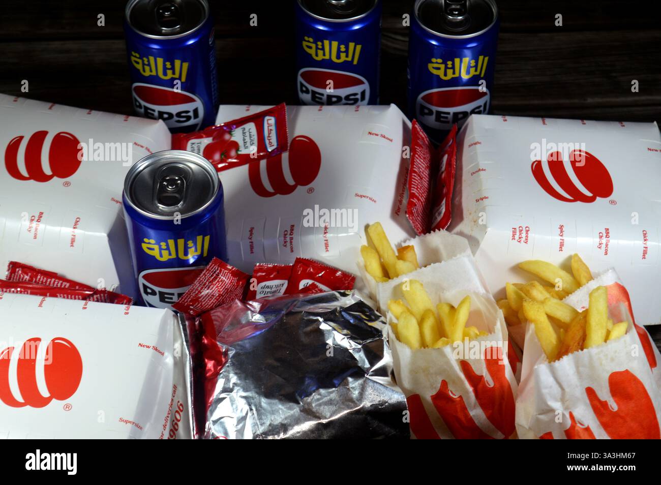 Cairo, Egypt, February 8 2025: Pepsi cans and Wimpy delivery fast food ...