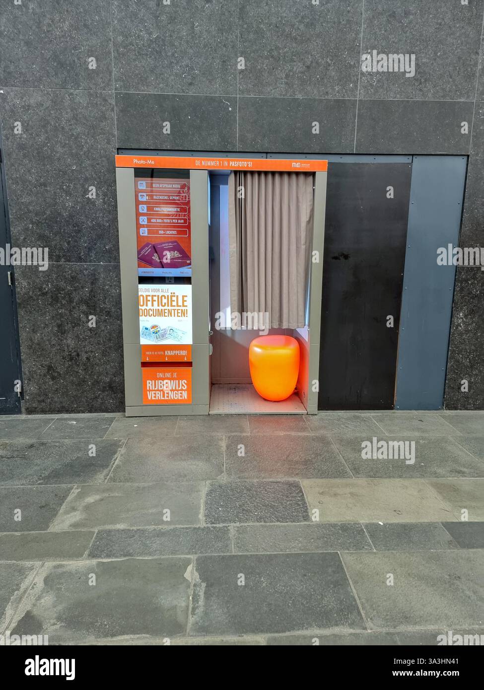 Photo booth / Photo kiosk with orange colors in tiled wall (in train ...