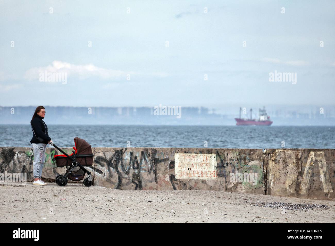 Non Exclusive: A woman with a pram looks at the Black Sea from the ...