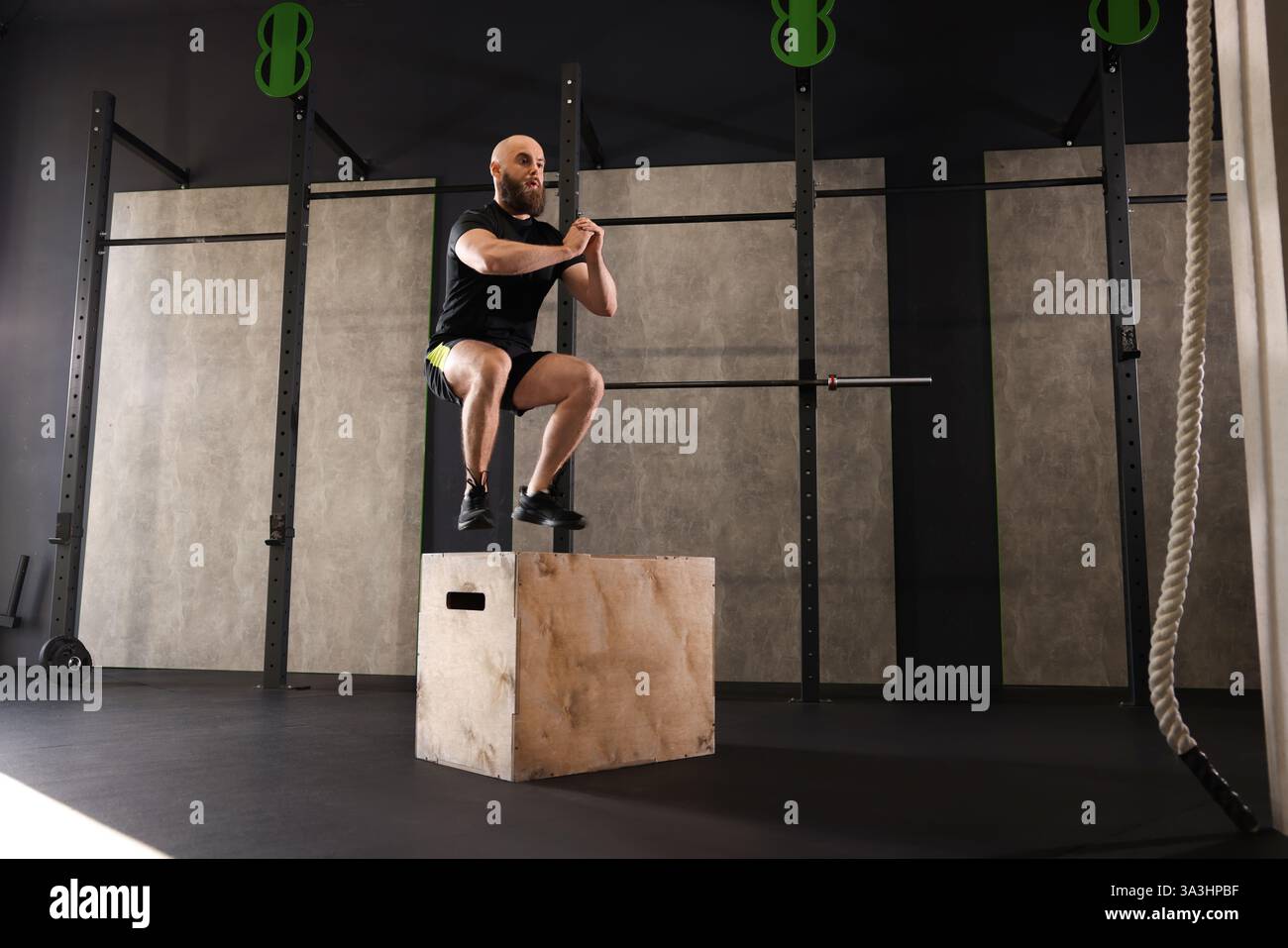 Sportsman doing box jumping during crossfit workout in gym Stock Photo ...
