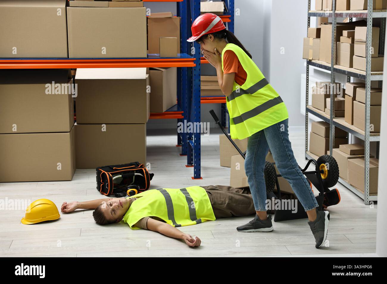 Accident at work. Worried woman and her unconscious colleague in ...