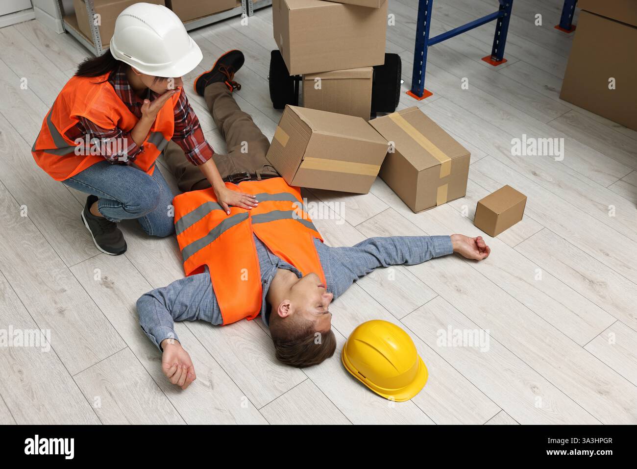 Accident at work. Worried woman and her unconscious colleague in ...