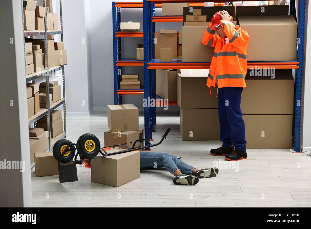 Accident at work. Worried man and his unconscious colleague in ...