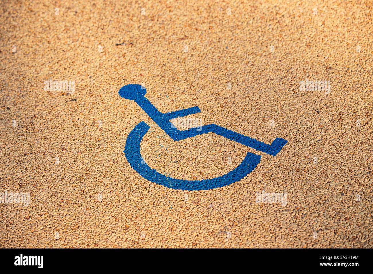 Blue wheelchair symbol painted on a grainy surface, promoting ...