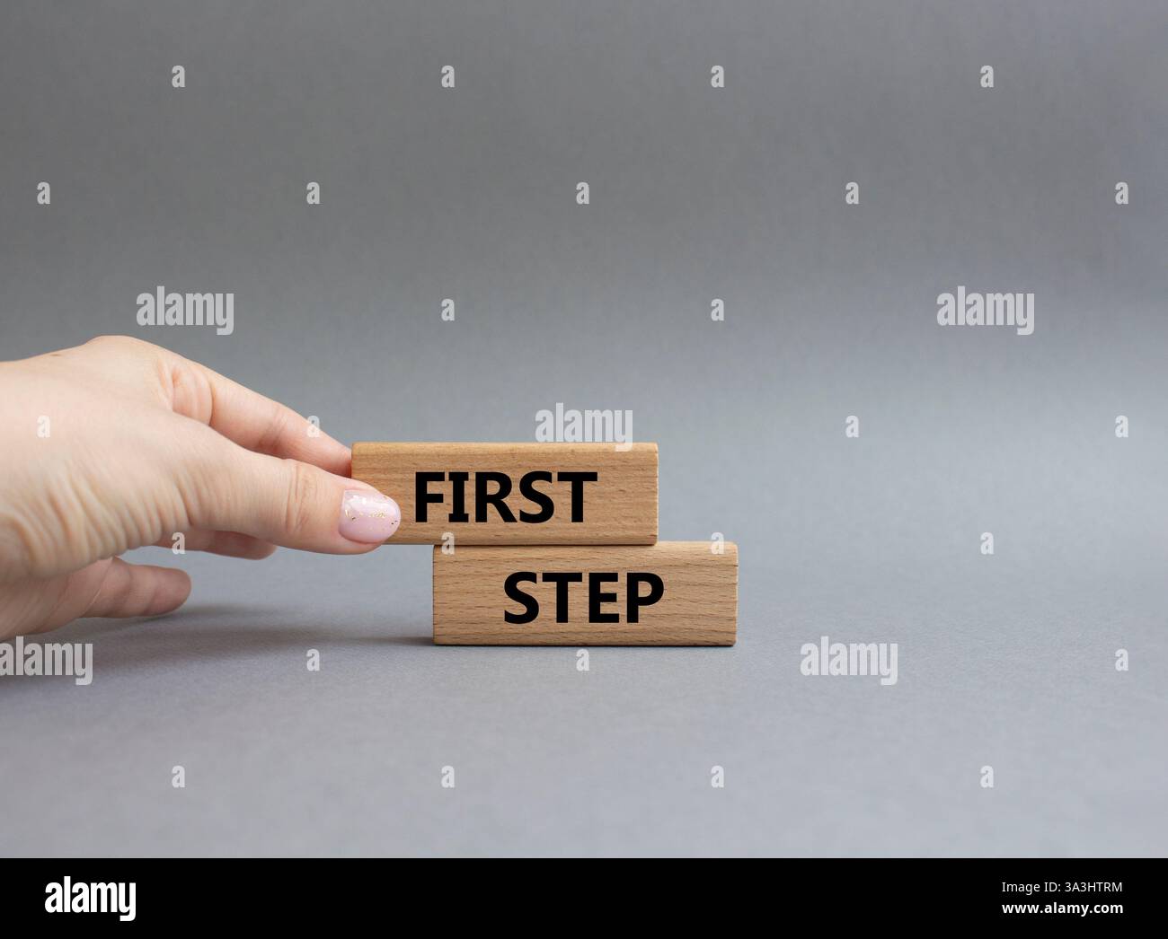 First step symbol. Wooden blocks with words First step. Beautiful grey ...